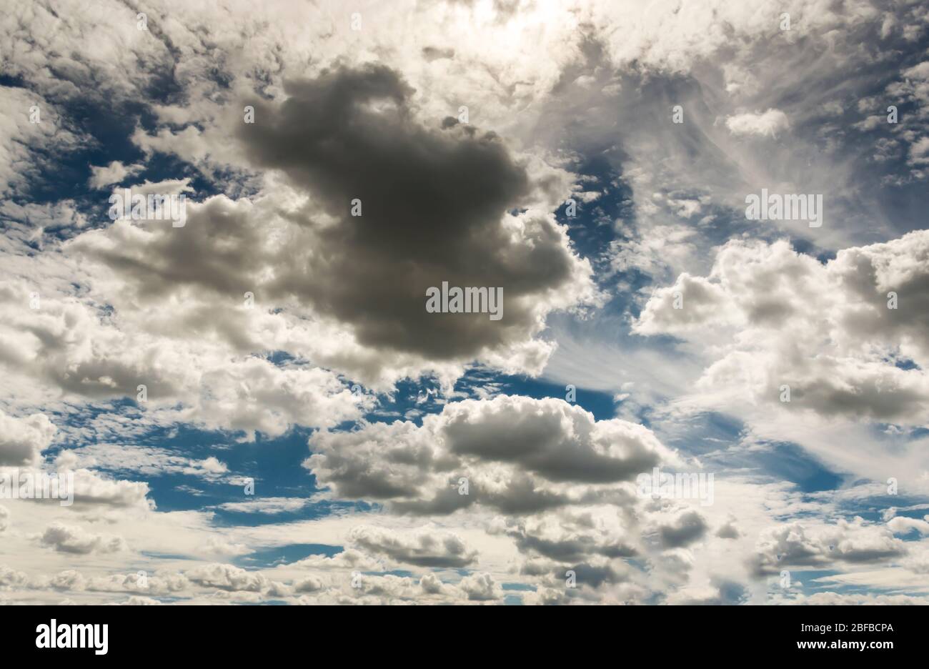 Dramatic cloud sky with dark rain clouds and sun before and after ...