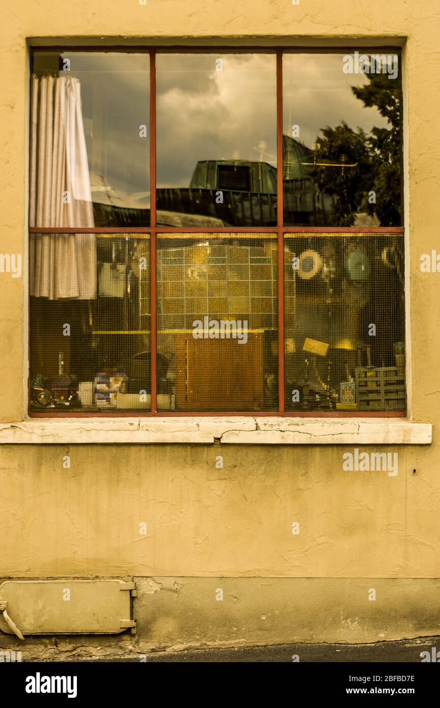 Window of a junk shop with reflection in a dilapidated facade Stock ...