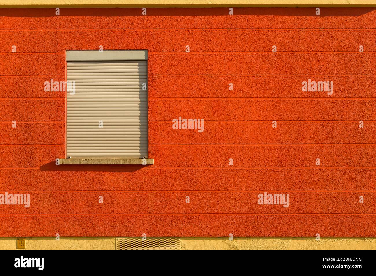 Facade with bright colors red orange yellow pedestal and a window ...