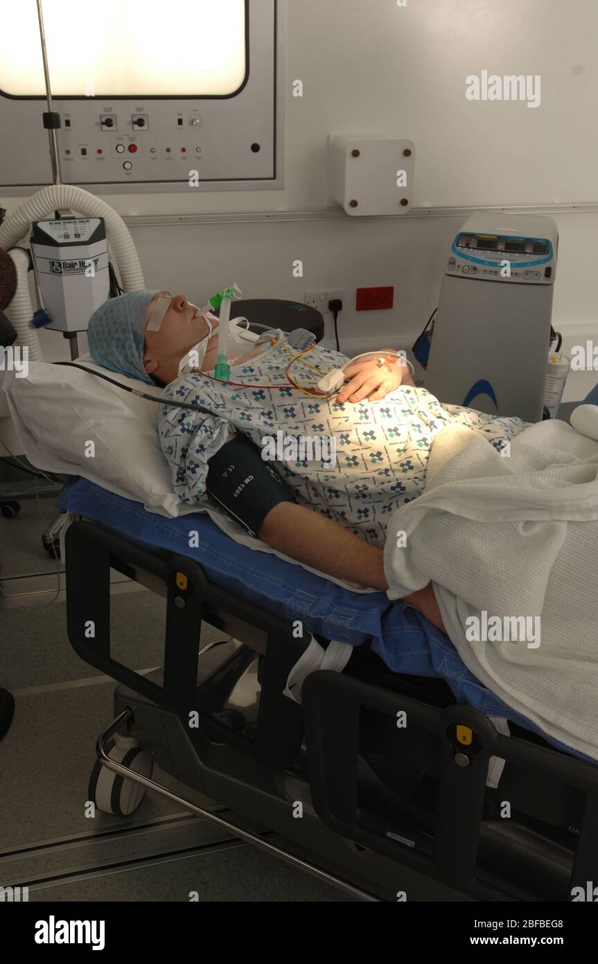 A patient under anaesthetic lies in a surgey prior to undergoing an ...