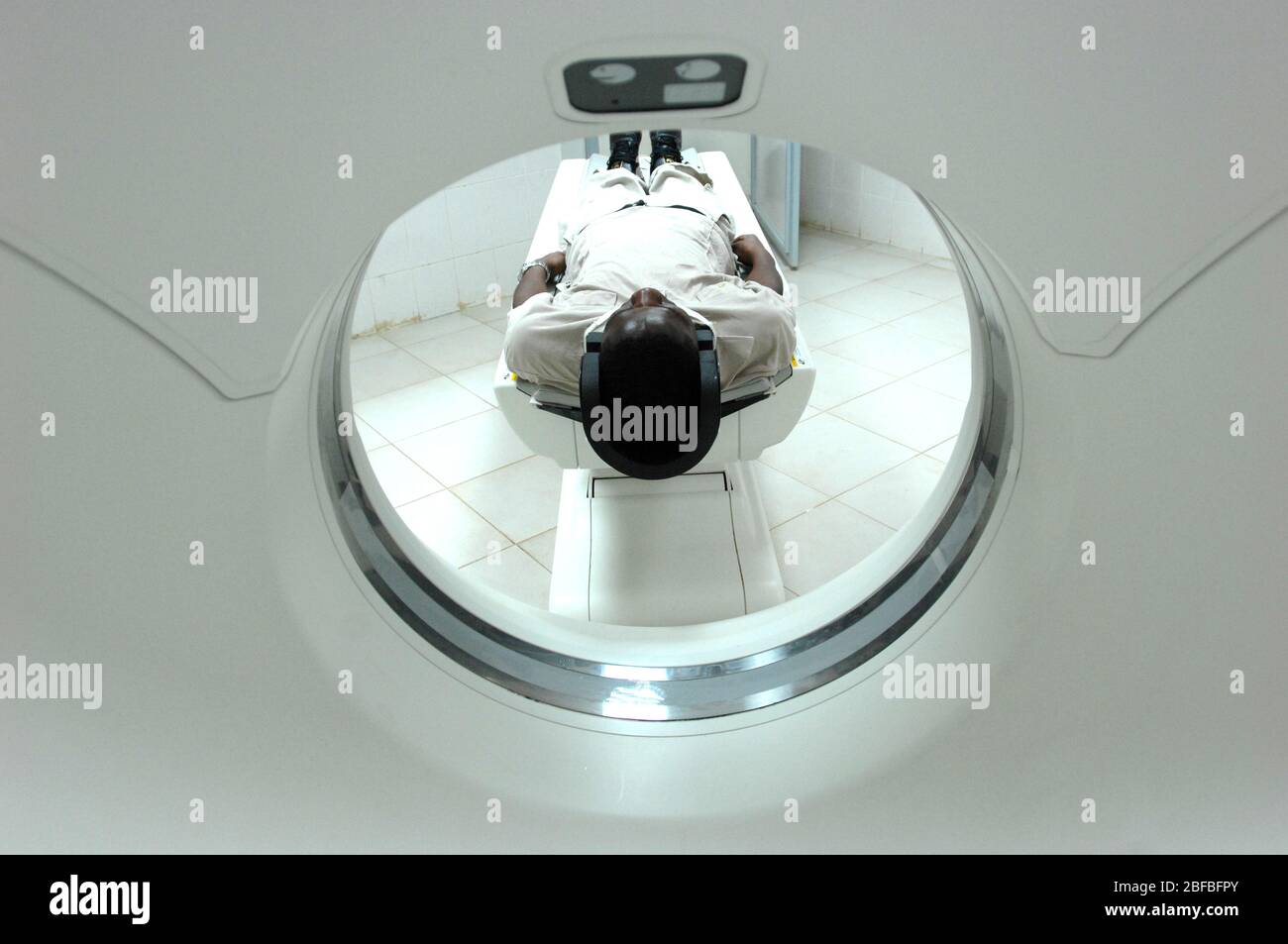 Patient undergoing a CT (Computd Tomography or CAT) scan of his head ...