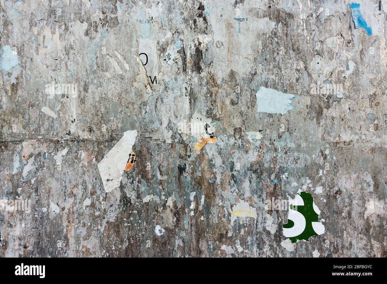 Street bulletin board with scraps of posters - Textured background with ...