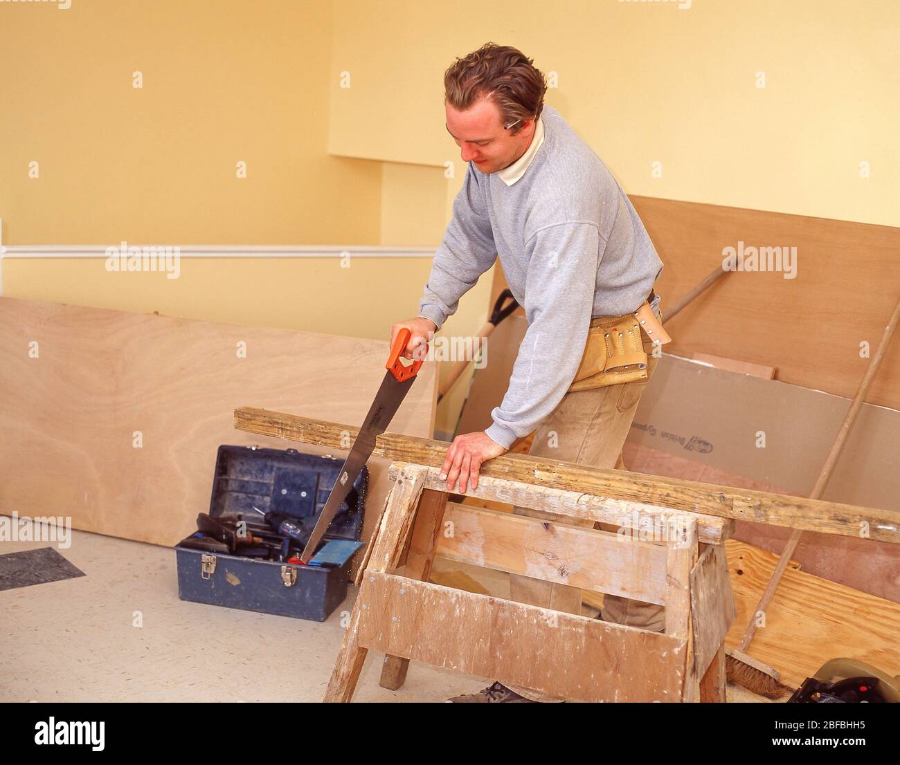 Male carpenter refurbishing office interior, Sunningdale, Berkshire ...
