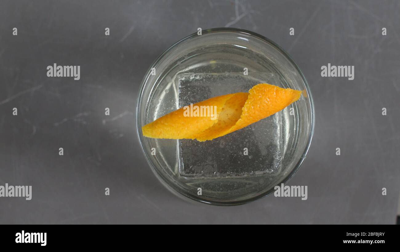 Clear cocktail with orange peel Stock Photo - Alamy