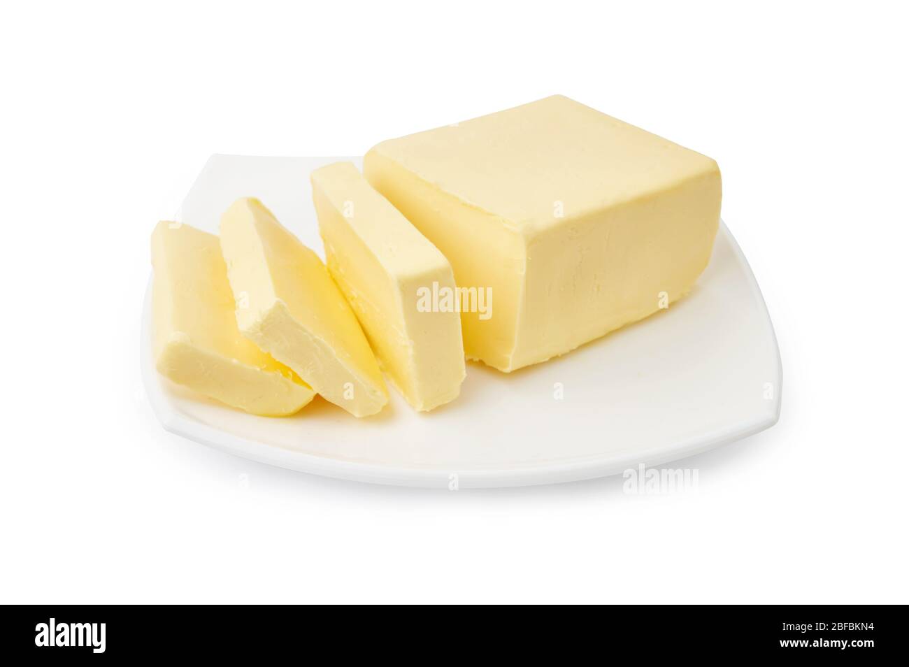 Sliced butter of piece butter on white plate isolated on white ...