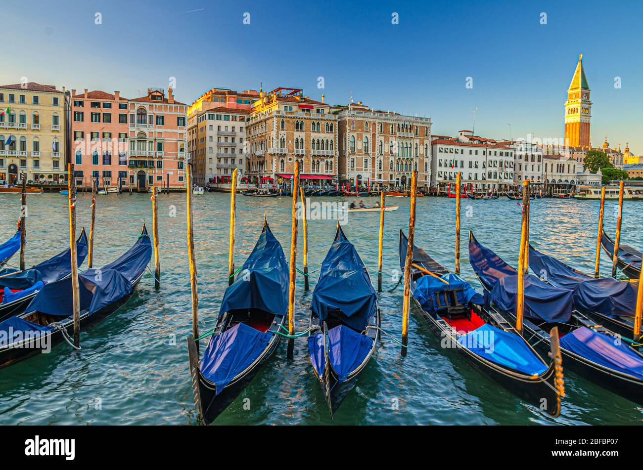 Gondolas moored on Grand Canal water in Venice. Baroque style colorful ...