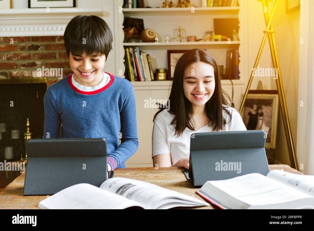 Siblings do their school work from home during social distancing ...
