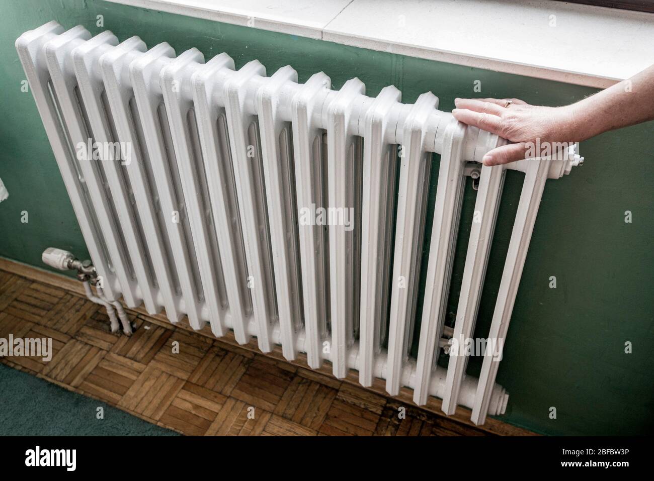 Heating radiator check by hand Stock Photo - Alamy