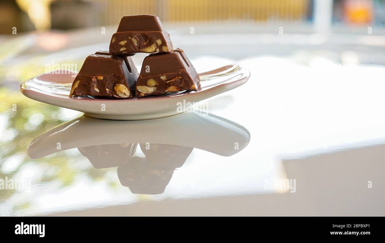 Chocolate bars containing nuts on a plate Stock Photo - Alamy