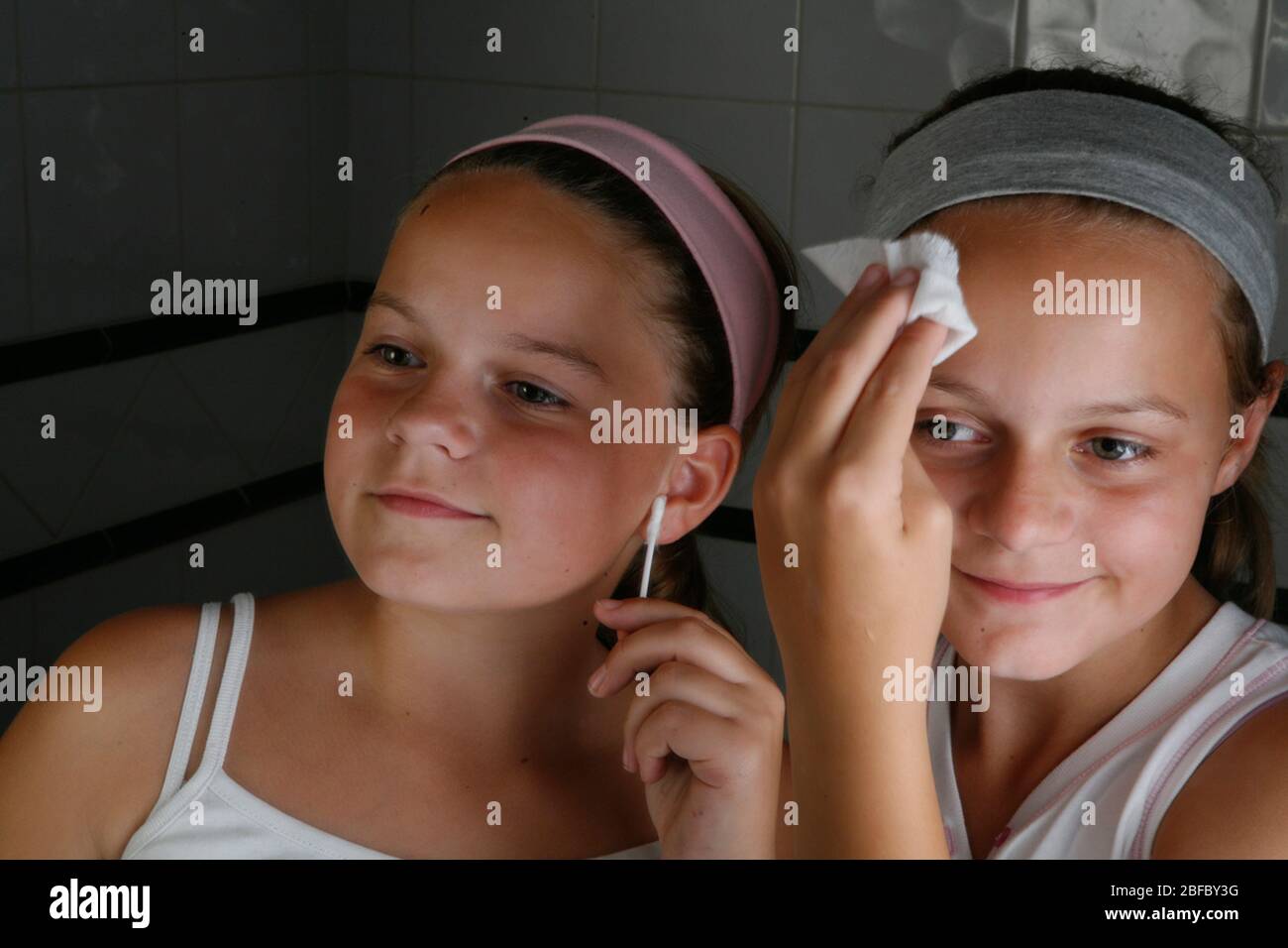 Two Girls washing their faces Stock Photo - Alamy
