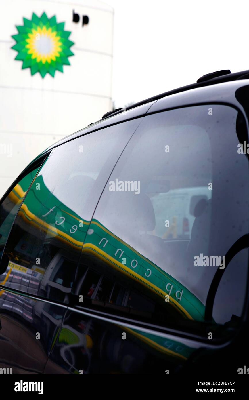 The BP logo at a petrol station with the BP Connect sign reflecting on ...