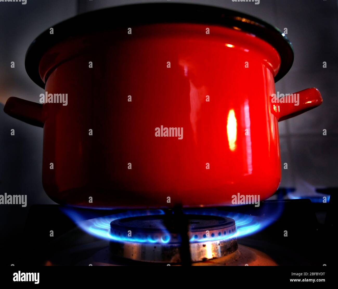 Picture shows a red pan on a gas stove Stock Photo - Alamy