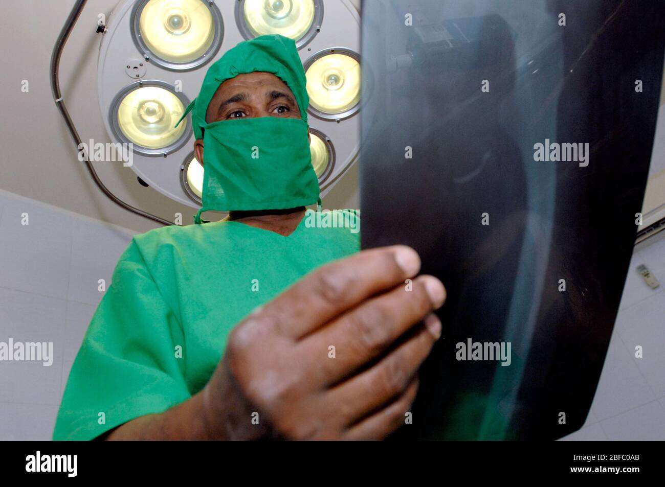 A radiologist examines an x-ray underneath the surgical theatre lights ...