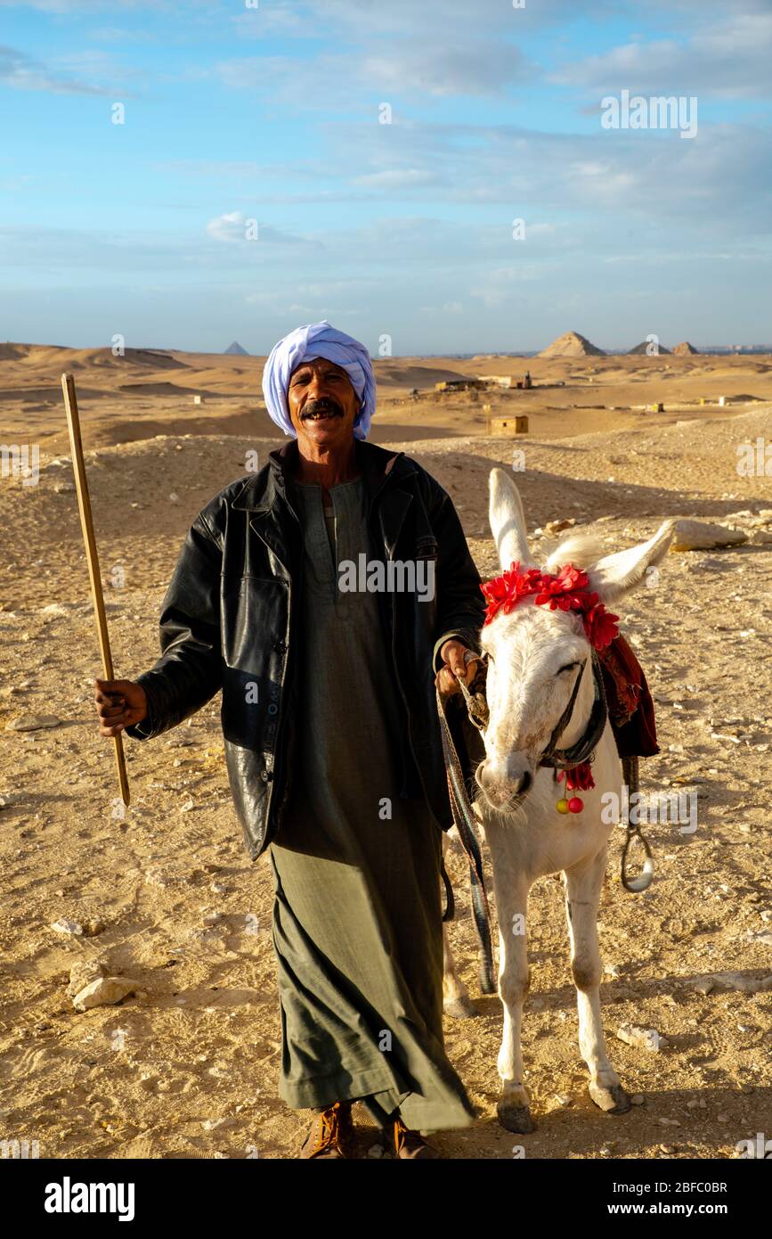 A man poses with his donkey at the stepped Pyramid of Djoser, Saqqara ...