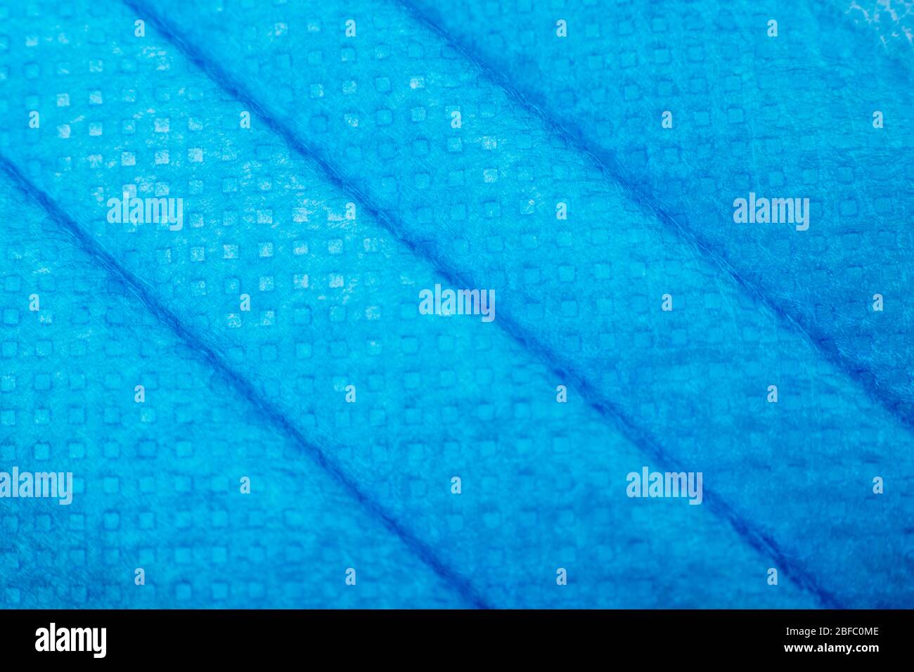 Blue macro surgical mask fabric texture. Selective focus, shallow depth ...
