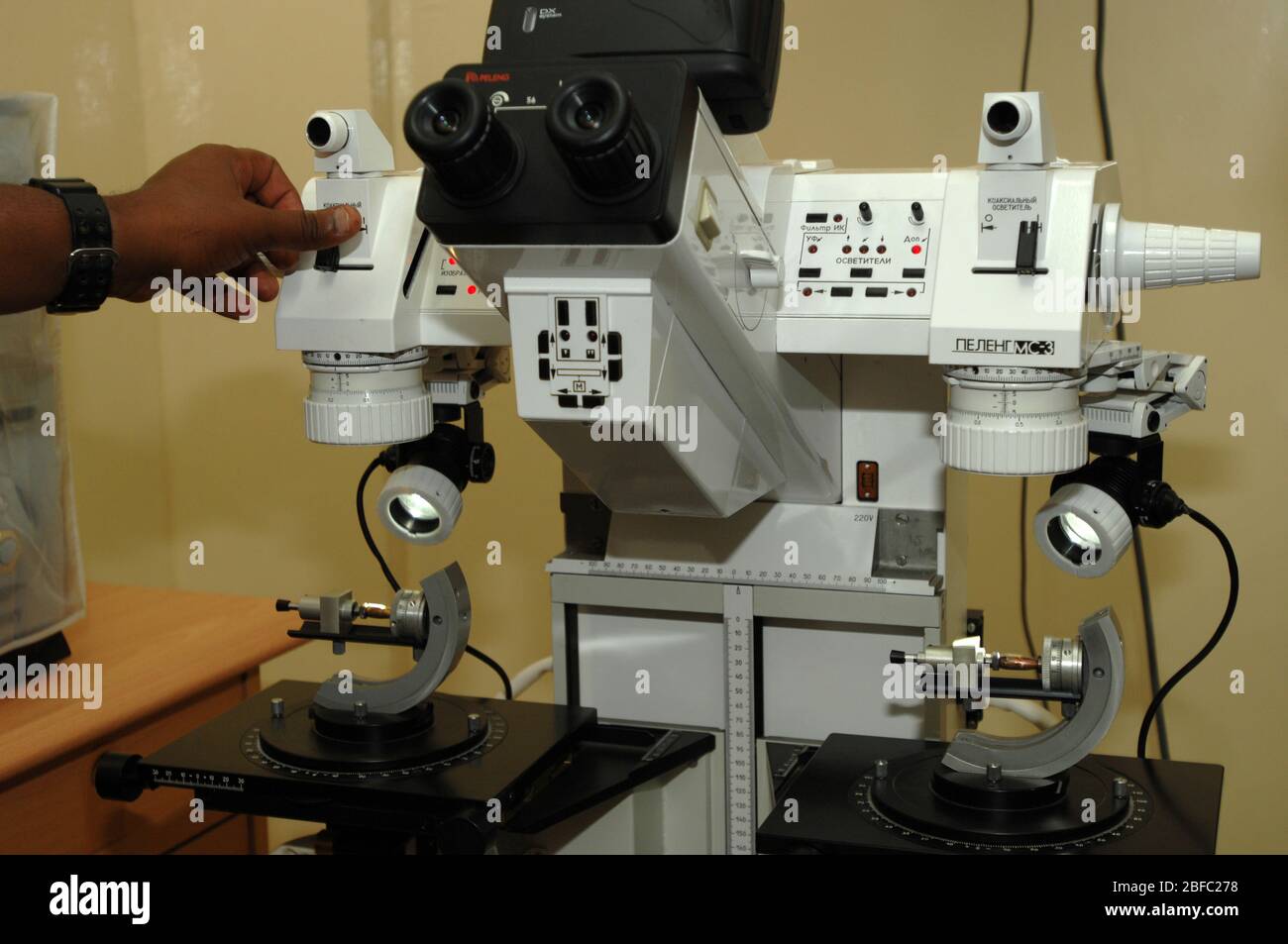 Hand gun cartridge shells held in microscope holders. The shells are ...