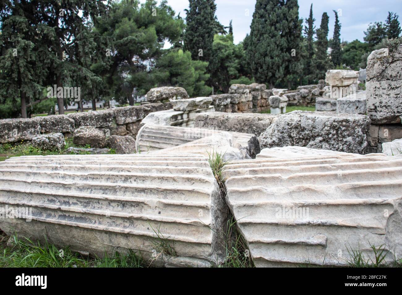 One broken columns with a huge crack laying on the ground in Athens ...