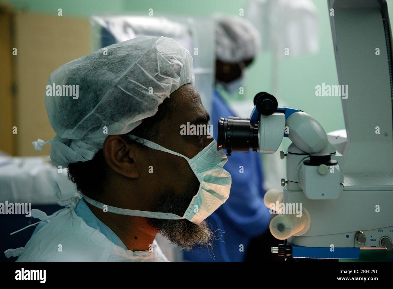 A surgeon uses a microscope during cataract surgery. The microscope ...