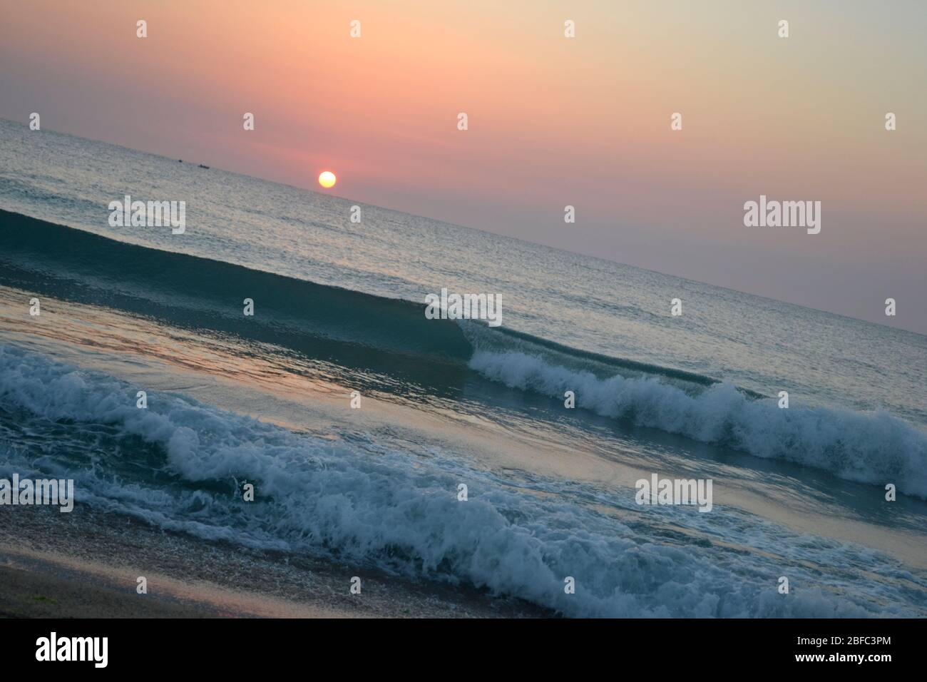 Sunset/ sunrise on a beach Stock Photo - Alamy