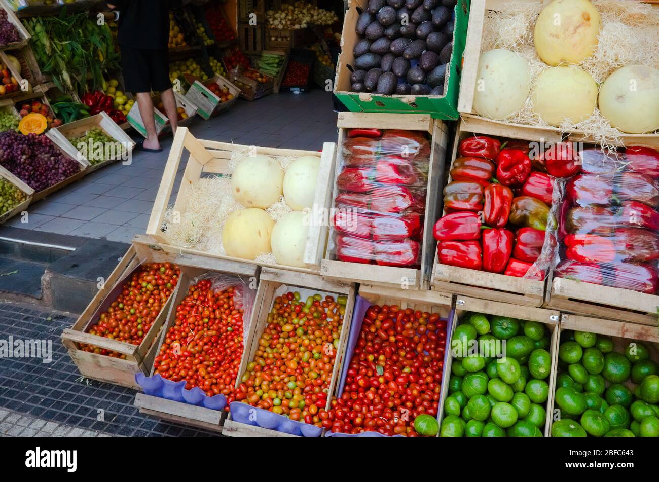 Street market vendor with groceries. Vegetables and fruits in wooden ...