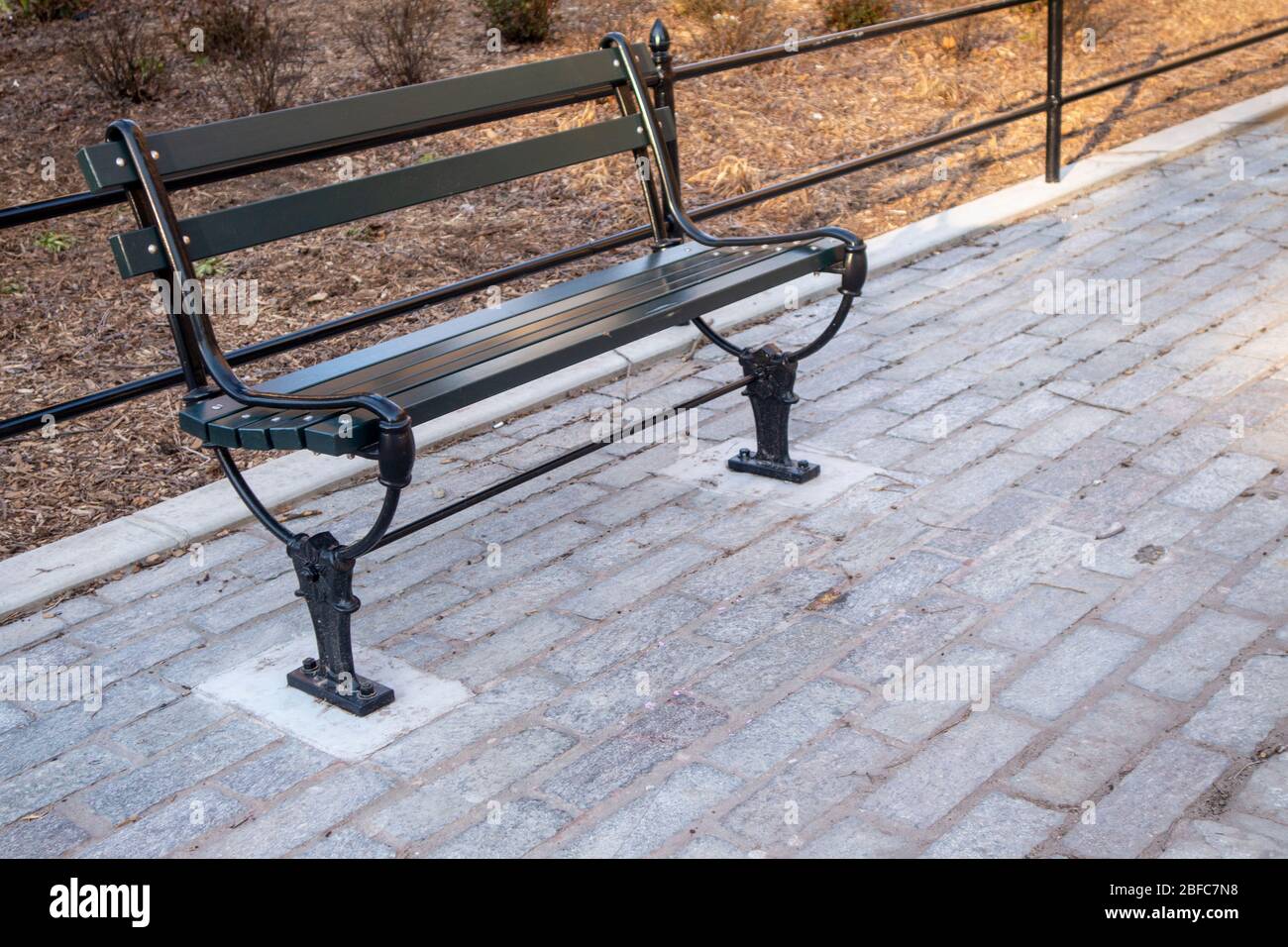 outdoor park walkway wood and metal park bench Stock Photo - Alamy