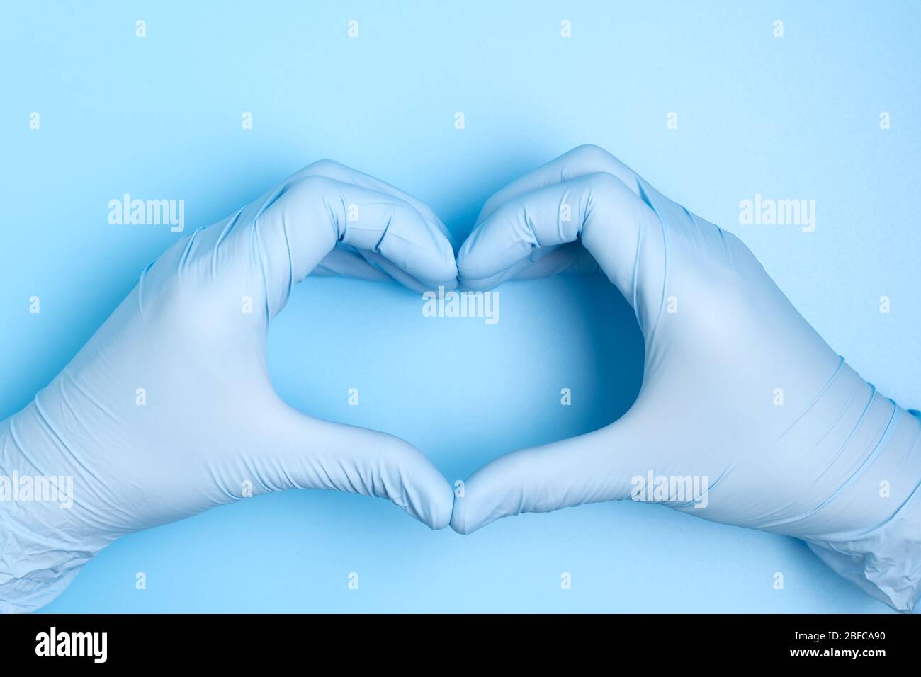 Doctor hands with gloves making heart shape Stock Photo - Alamy