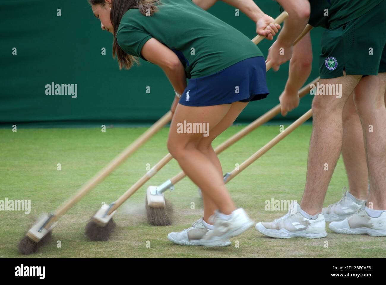 Ground staff sweep the courts of the Wimbledon Championships at the All ...