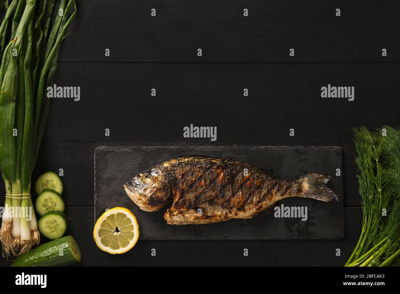 Dorado fish cooked with lemon and fresh vegetables Stock Photo - Alamy