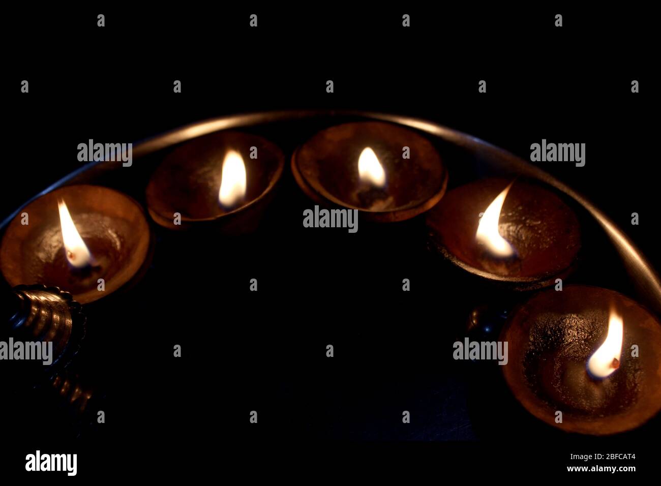 Traditional vintage clay oil lamp burning fire, festival lamp of ...