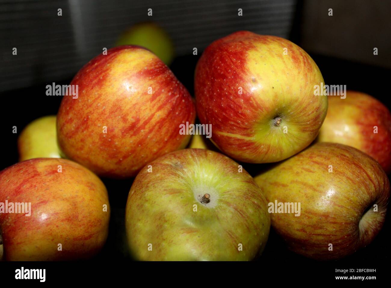 group of Colorful fruit pattern of fresh apples on black background ...