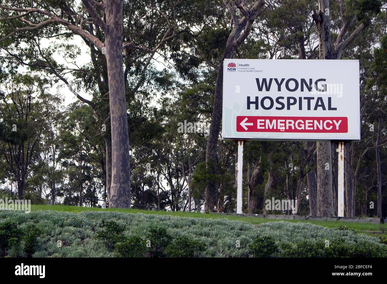 Hospital entrance, and sign directing to the Emergency department of a ...