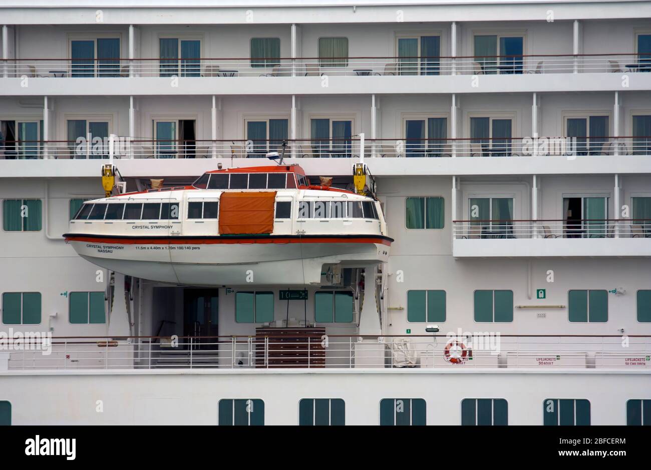 A Cruise ship excursion boat hoisted on davits alongside cabins Stock ...