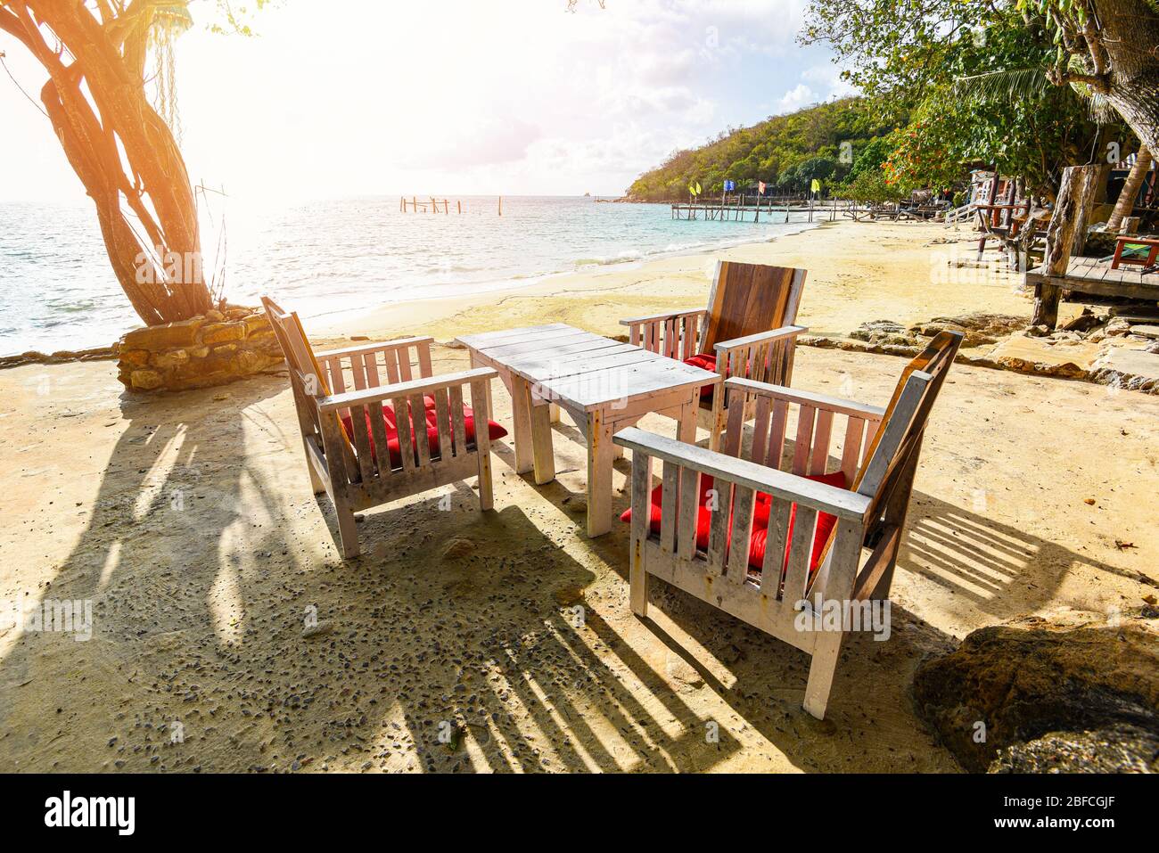 wooden table set on the beach view of sea waves and coast landscape ...