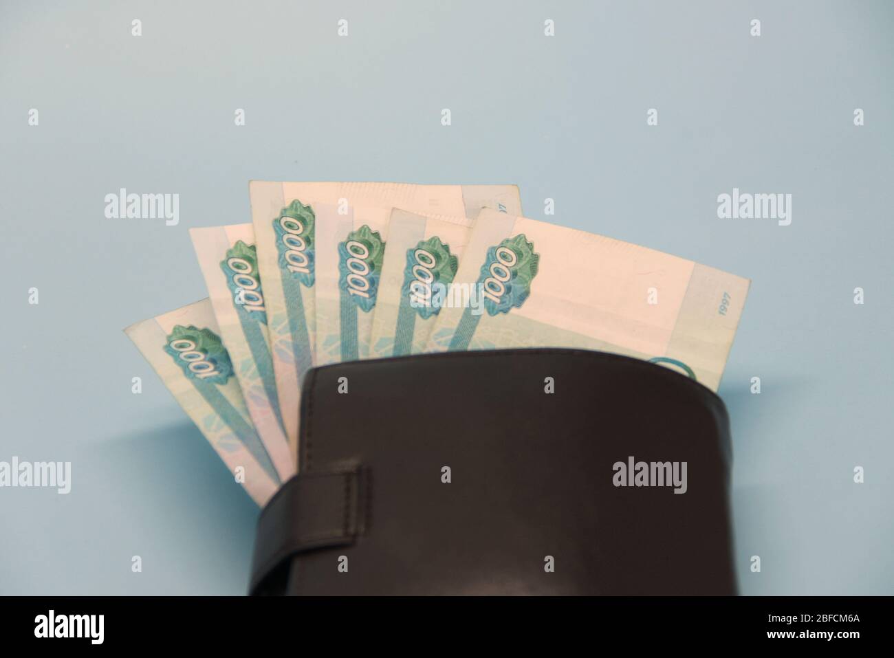 Leather brown wallet with Russian money sticking out of it in banknotes ...