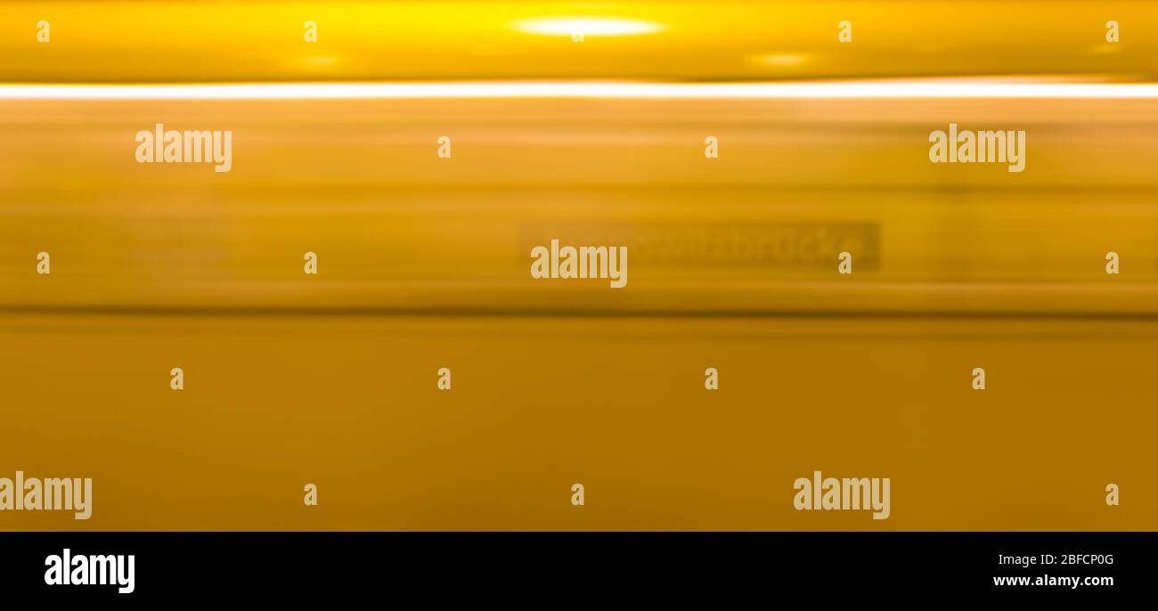 A yellow subway enters the train station Stock Photo - Alamy