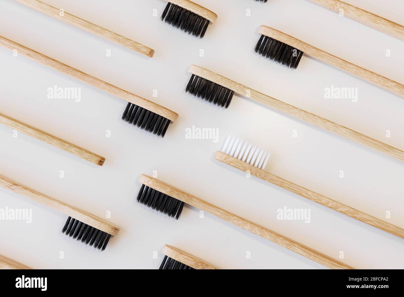 Group of black and one white bamboo toothbrushes pattern. White ...