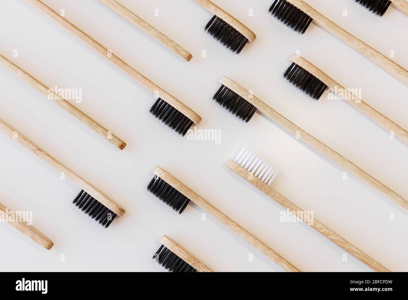 Group of black and one white bamboo toothbrushes pattern. White ...