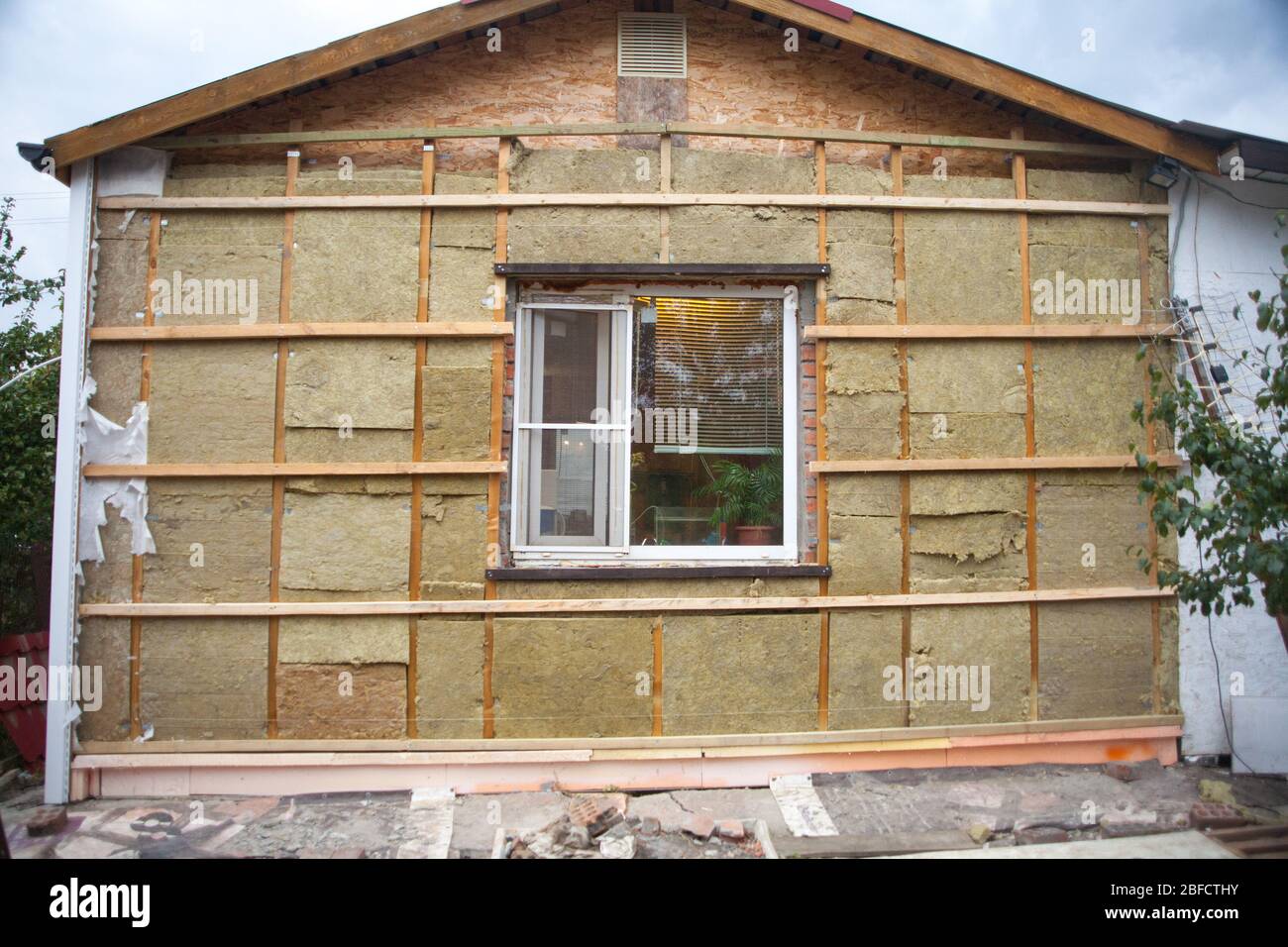 warming the walls of a stone house with a stone wool heater. Ecological ...