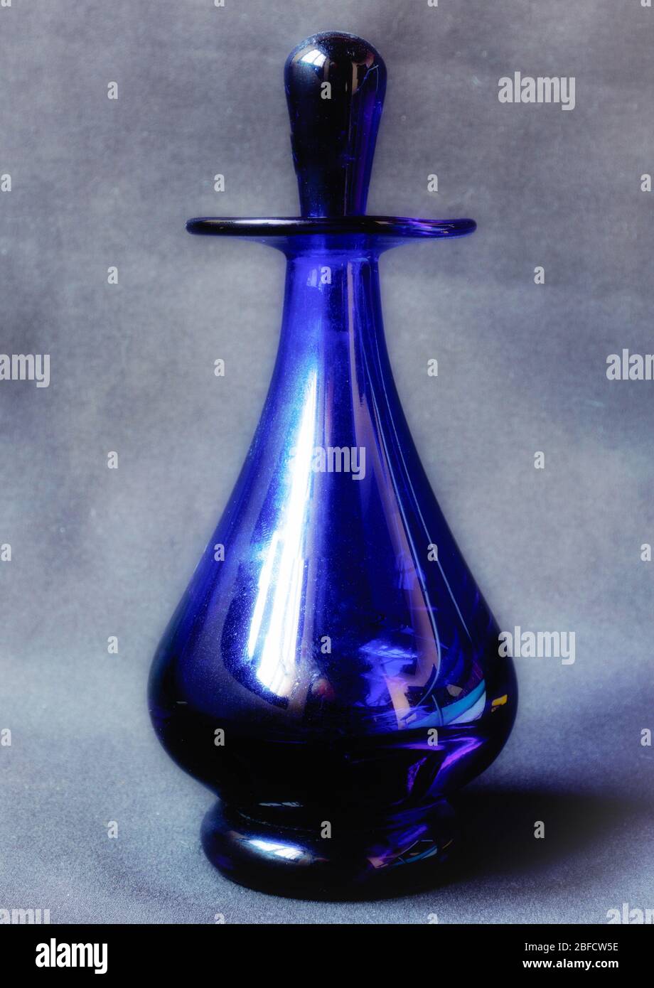 A Blue glass Victoria Scent Bottle in soft focus ethereal lighting ...