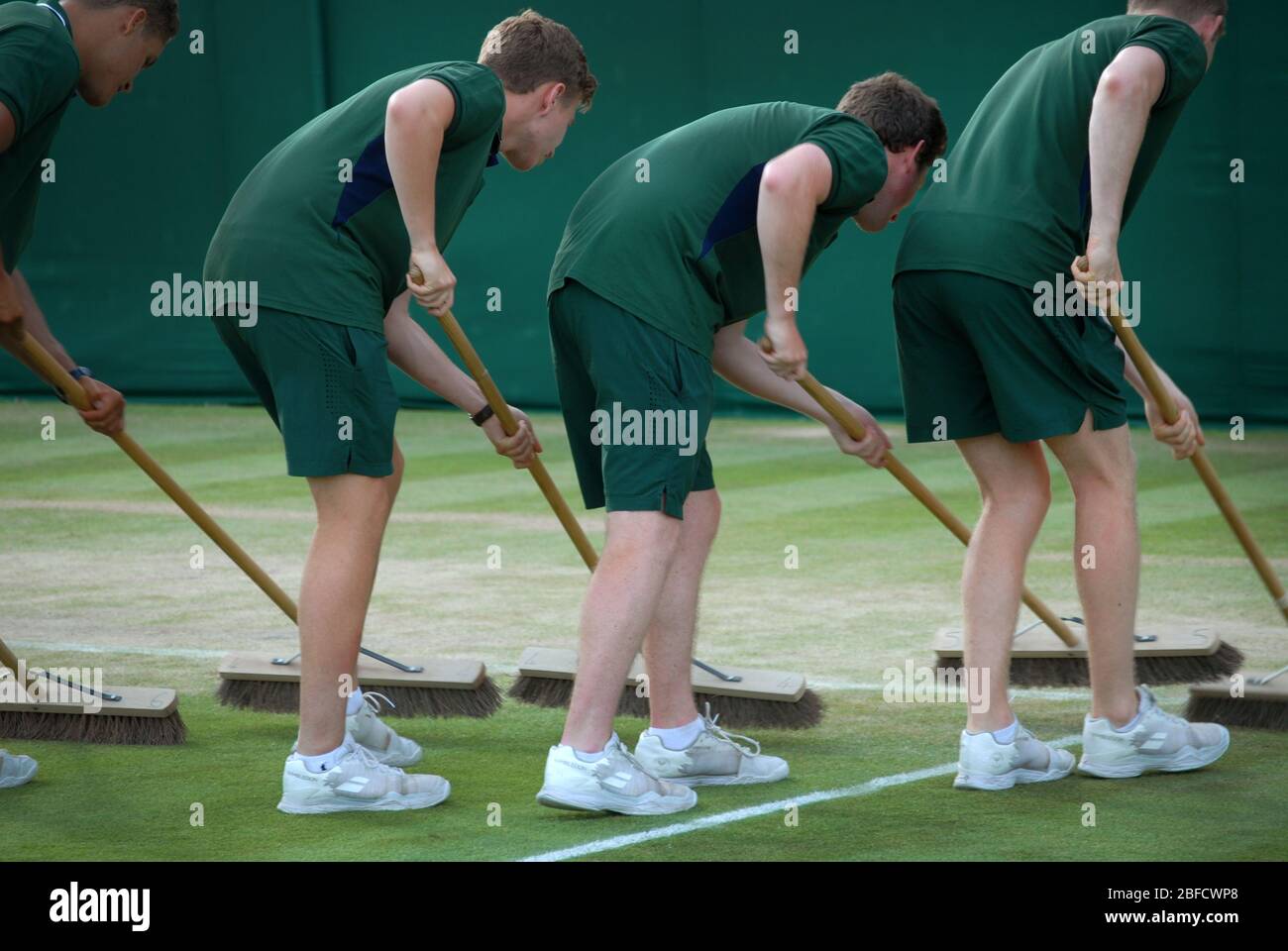 Ground staff sweep the courts of the Wimbledon Championships at the All ...
