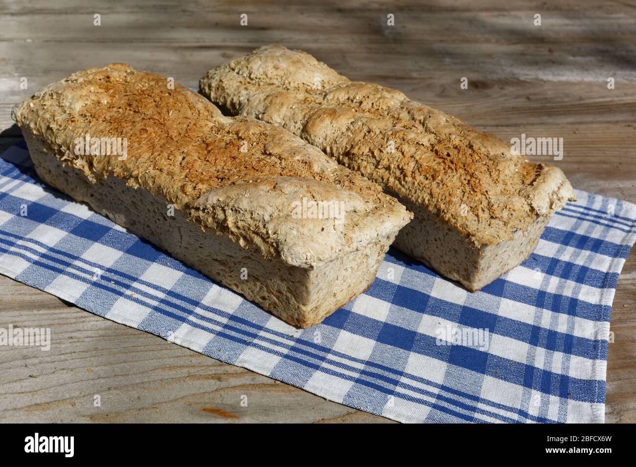 Homemade loaf of bread on kitchen cloth. Traditional handmade bread ...