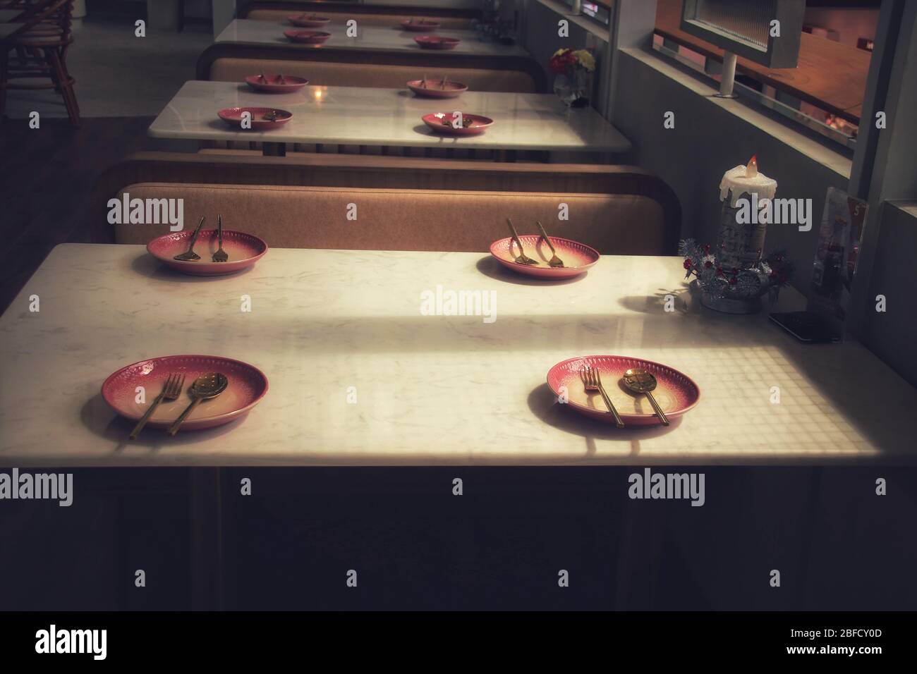 Empty plates and table at a restaurant shows the loneliness, economic ...