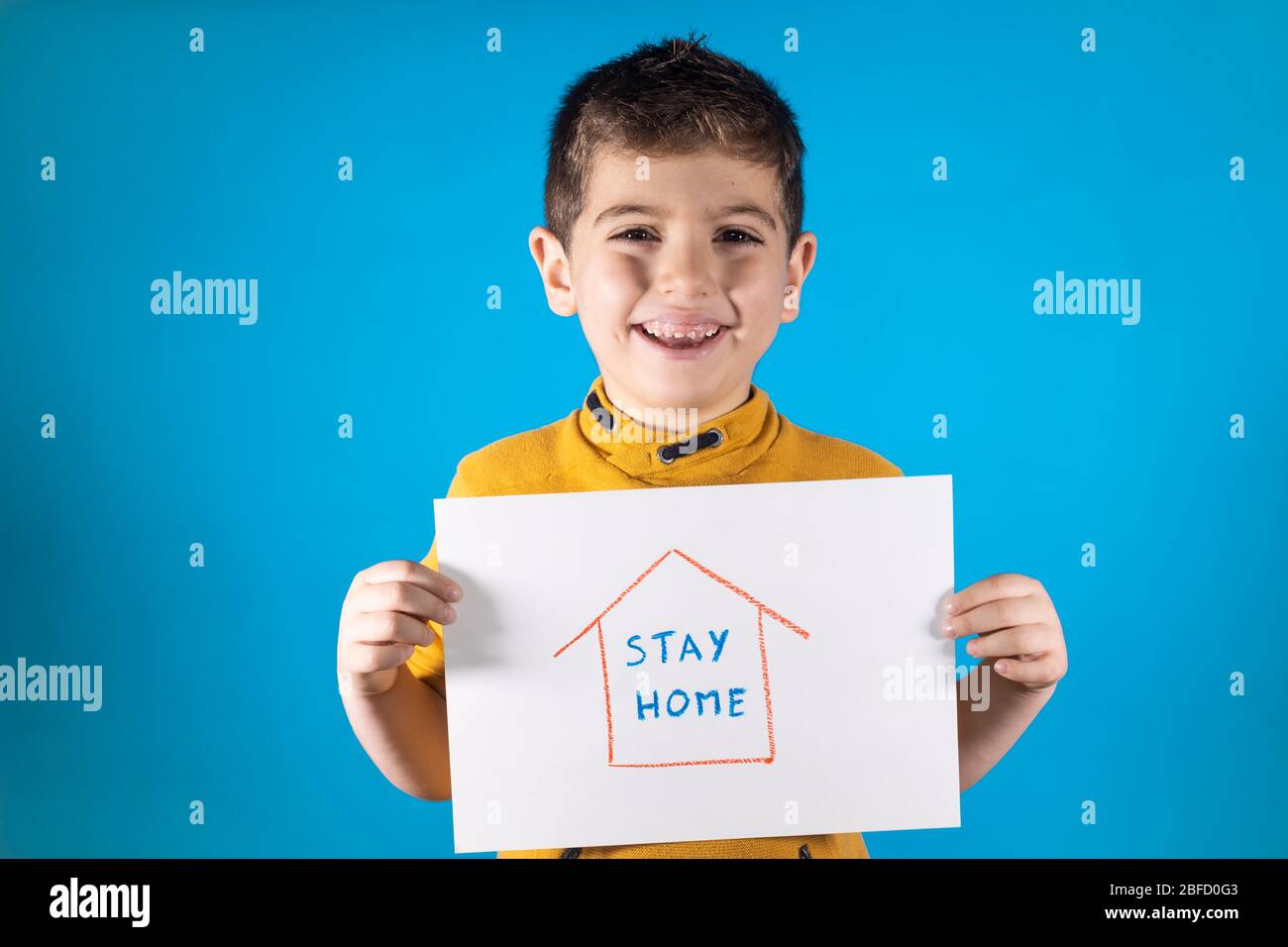 Little kid showing a Stay Home drawing Stock Photo - Alamy
