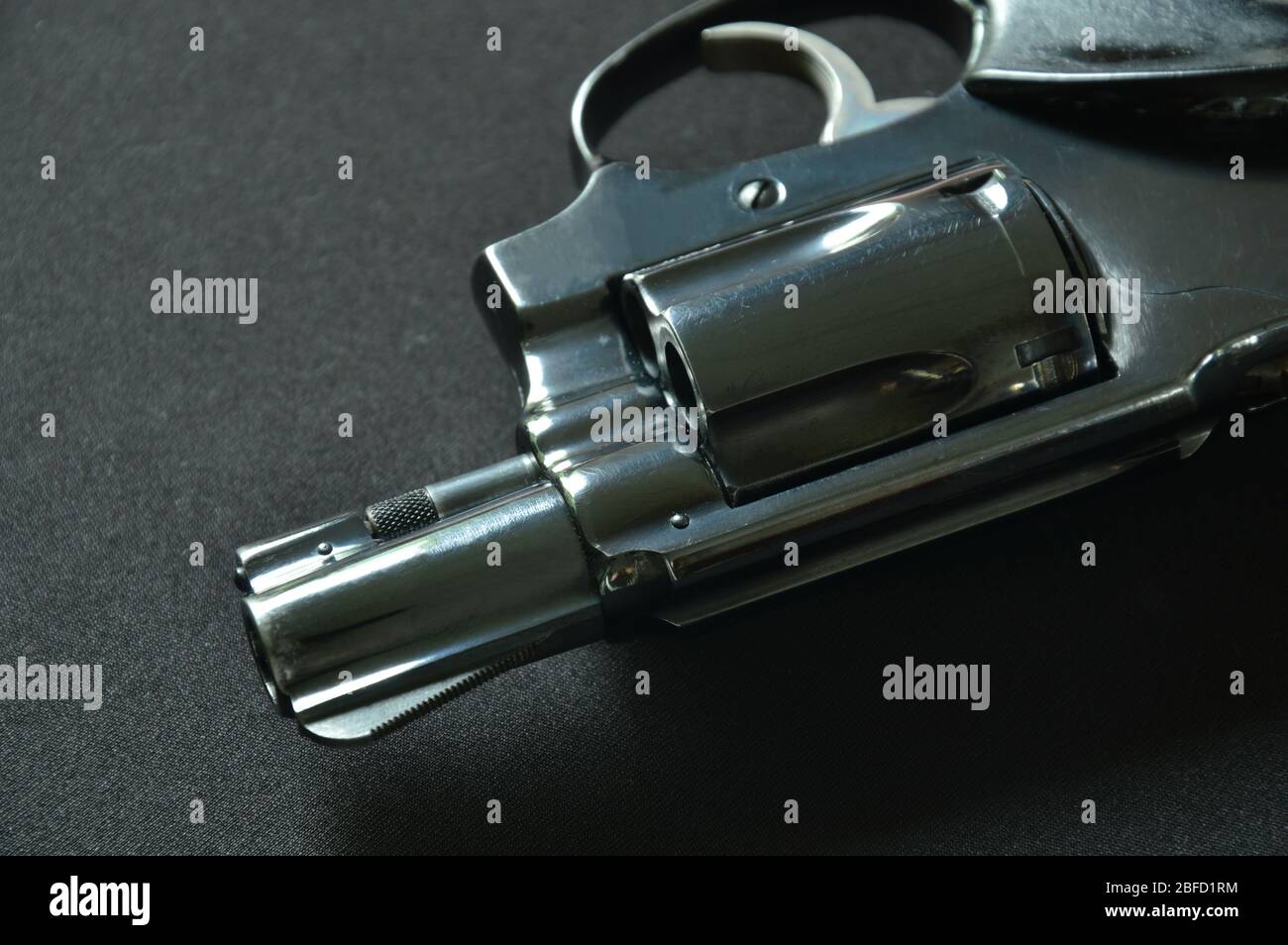 revolver gun on black fabric background Stock Photo - Alamy