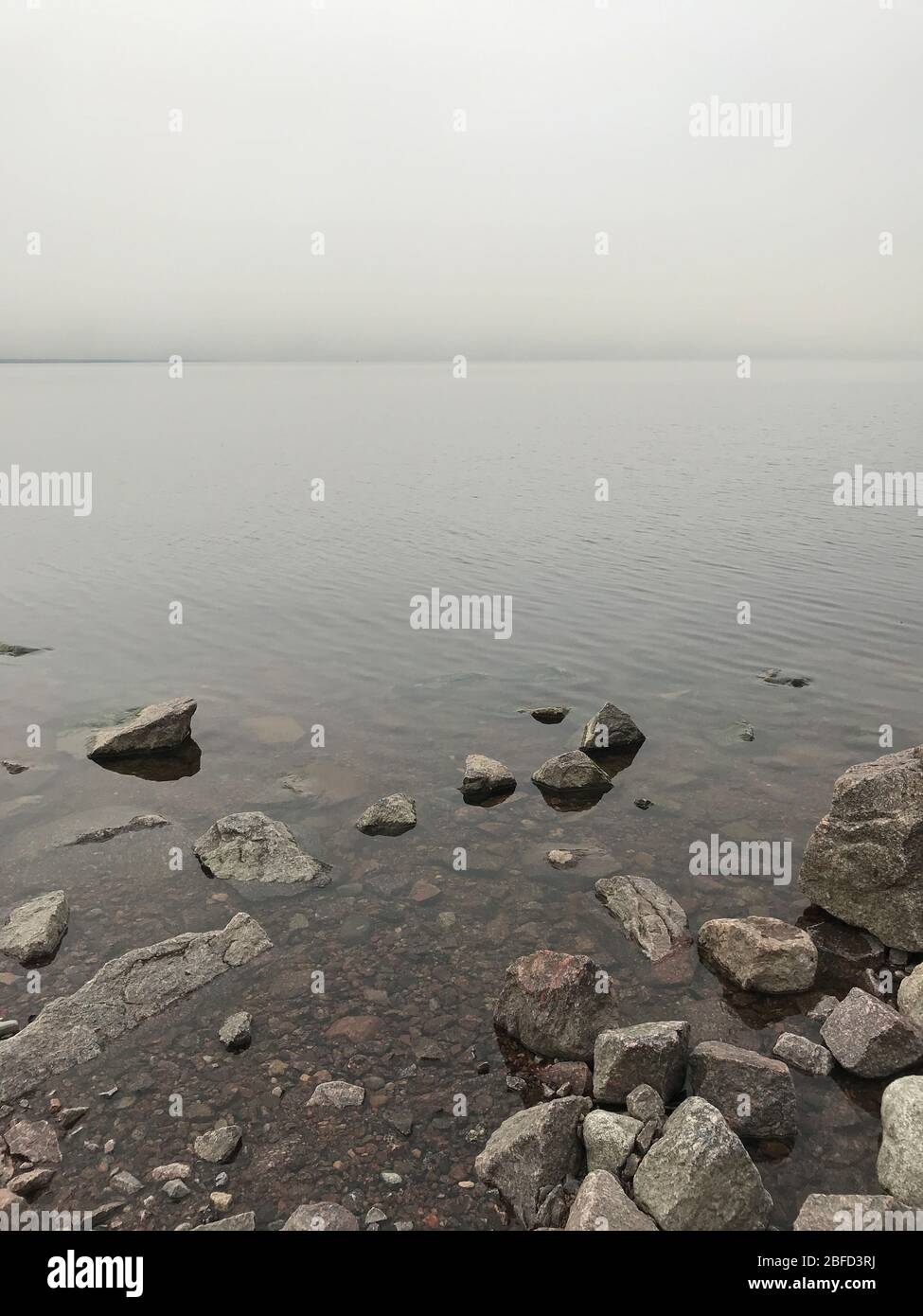 Calm waves at the Gulf of Finland at overcast foggy day, line of ...
