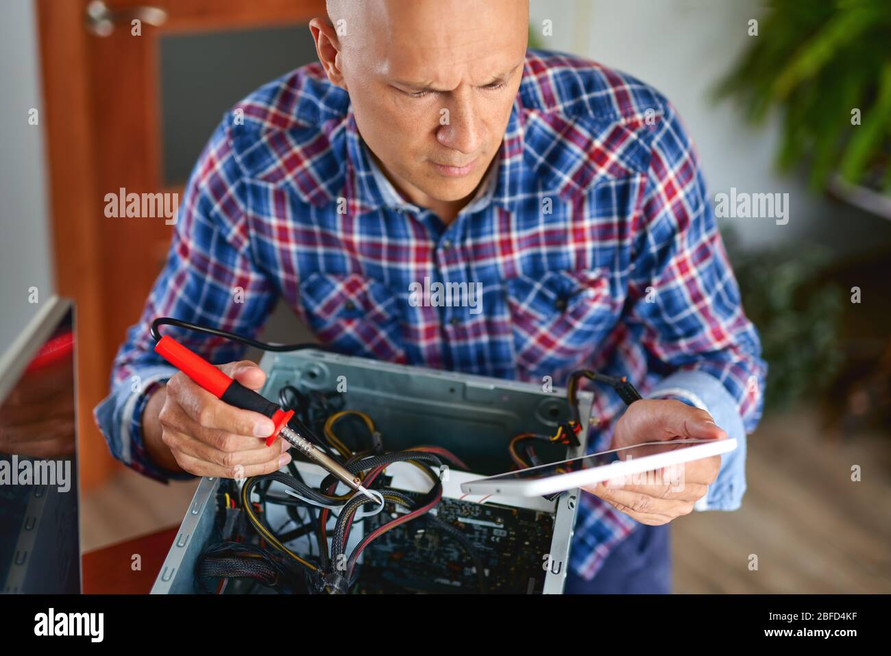 Male technician repairing motherboard hi-res stock photography and ...