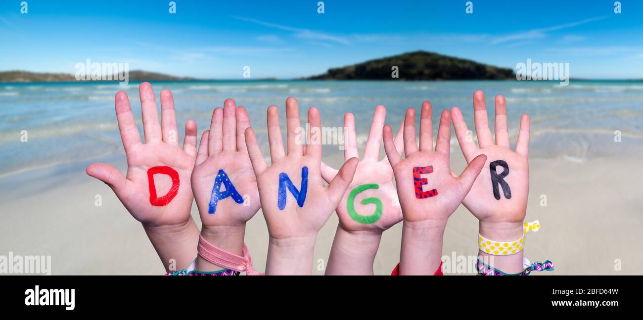 Children Hands Building Word Danger, Ocean Background Stock Photo - Alamy