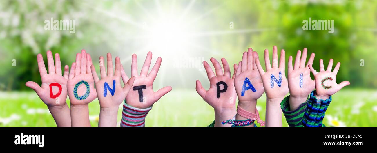 Kids Hands Holding Word Do Not Panic, Grass Meadow Stock Photo - Alamy