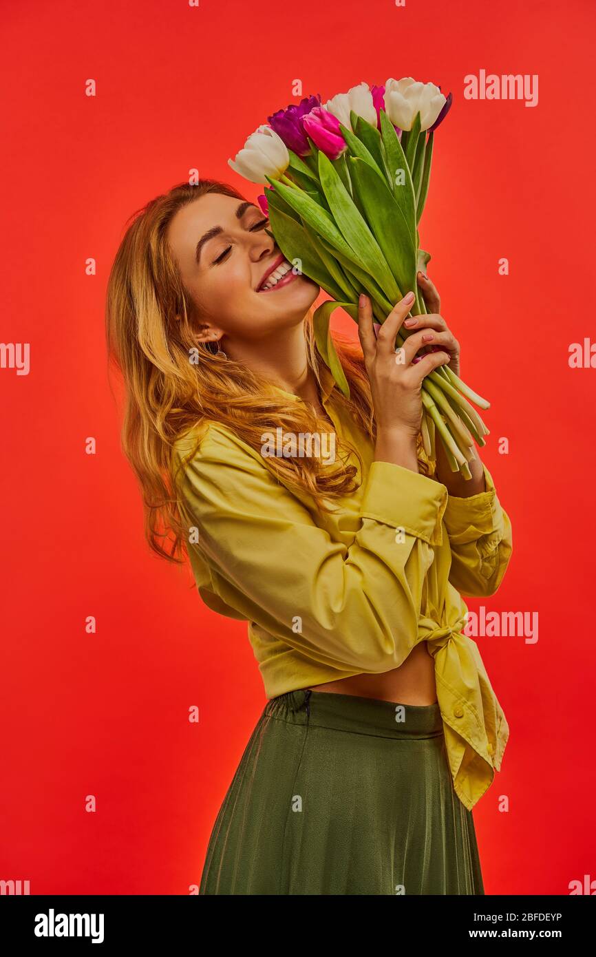 A girl hugs flowers and enjoys them Stock Photo - Alamy