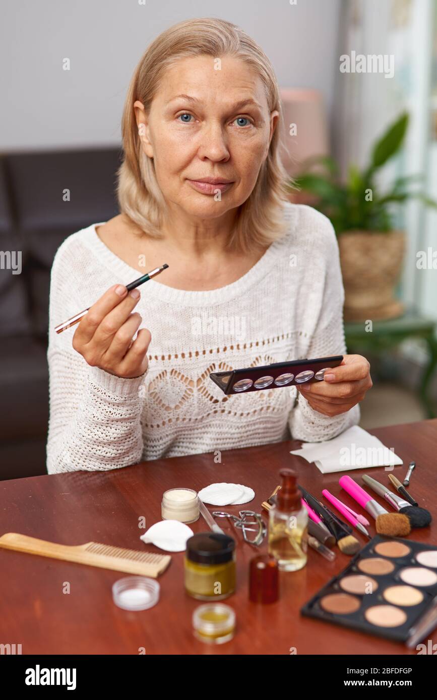 Elderly Woman Putting On Make-Up at home Stock Photo - Alamy